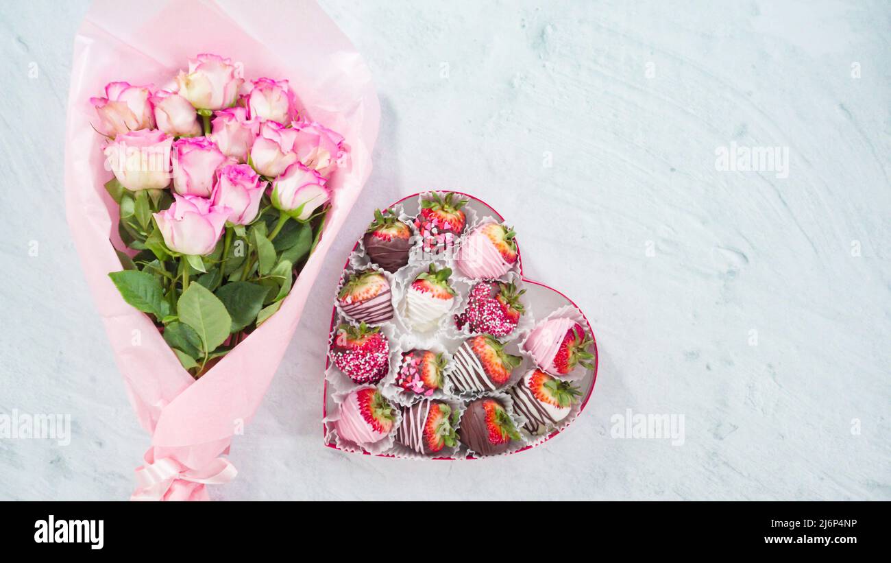 Flat lay. Step by step. Bouquet of pink roses with a box of chocolate ...