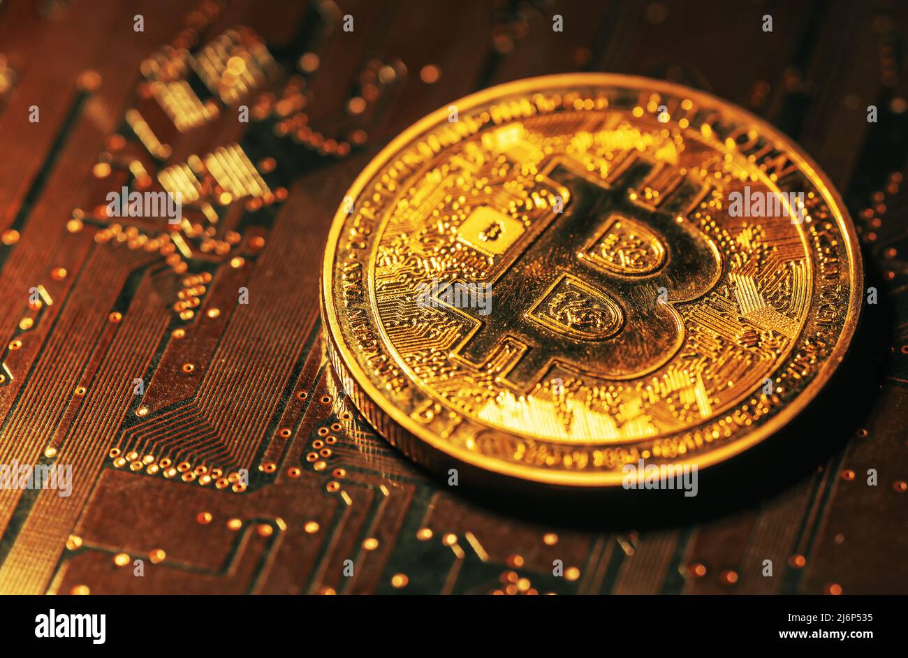Physical version of golden bitcoin on microchip Stock Photo - Alamy
