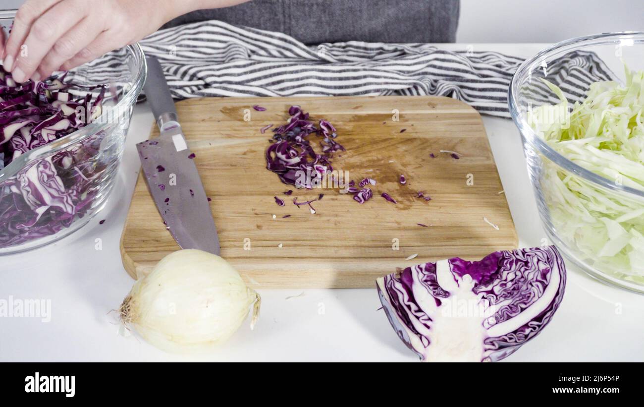 Step by step. Shredding organic cabbage on a wood cutting board Stock ...