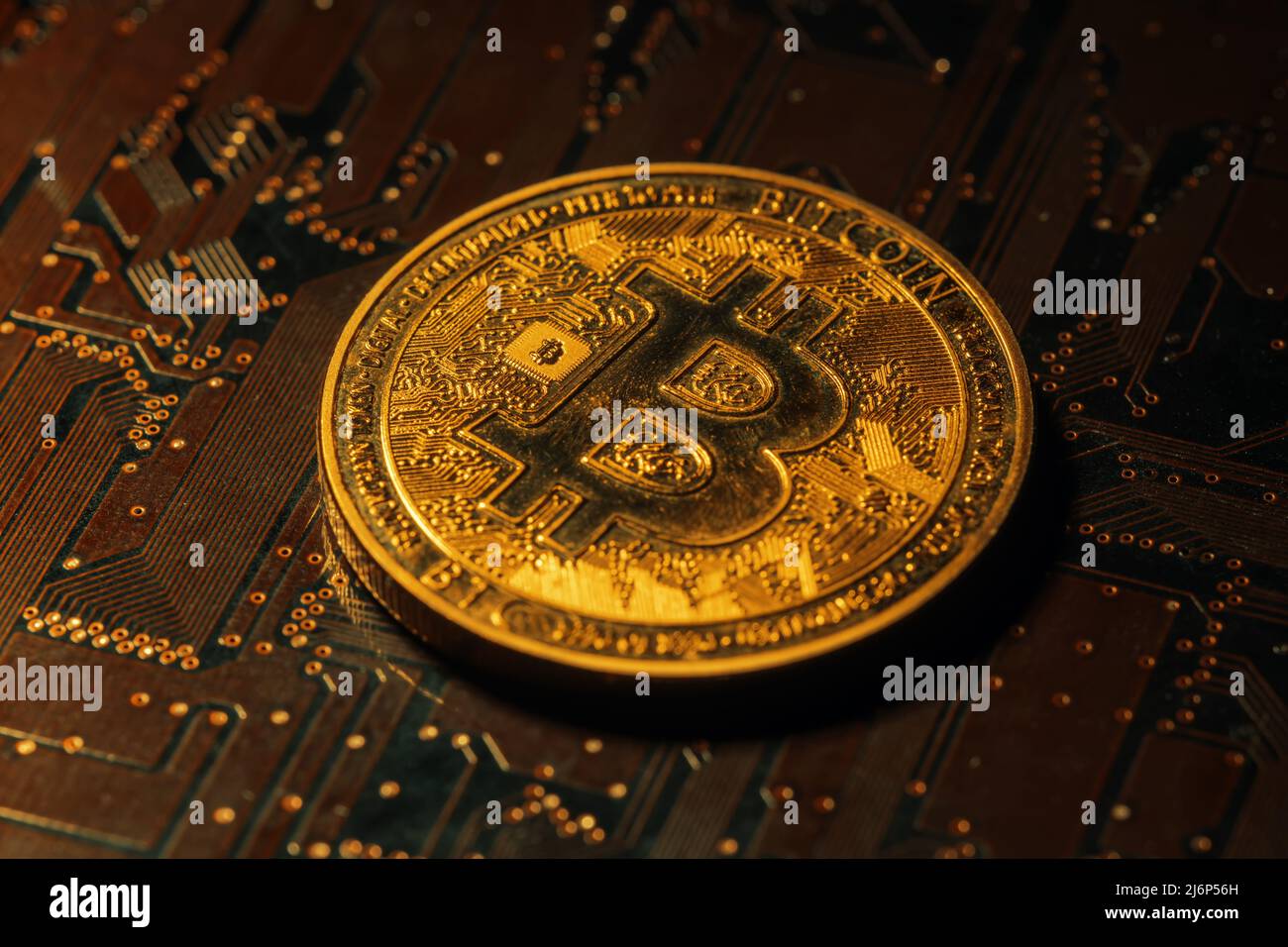Physical version of golden bitcoin on microchip Stock Photo - Alamy
