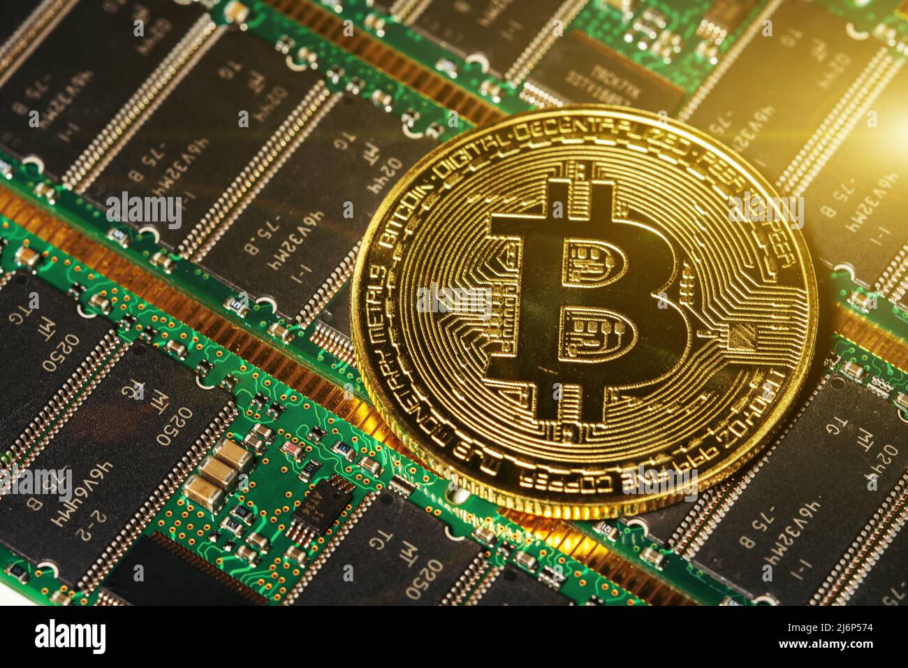 Physical version of golden bitcoin on microchip Stock Photo - Alamy