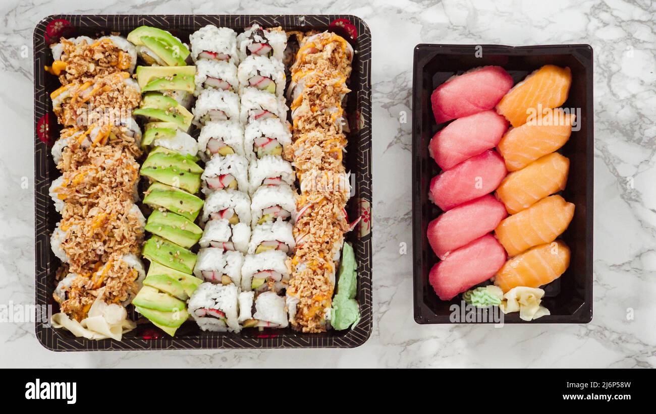 Flat lay. Pre-packaged variety of sushi and sushi rolls in a plastic ...