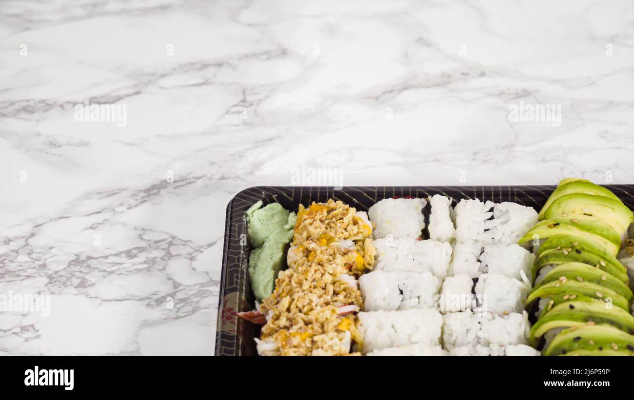 Pre-packaged variety of sushi and sushi rolls in a plastic tray Stock ...