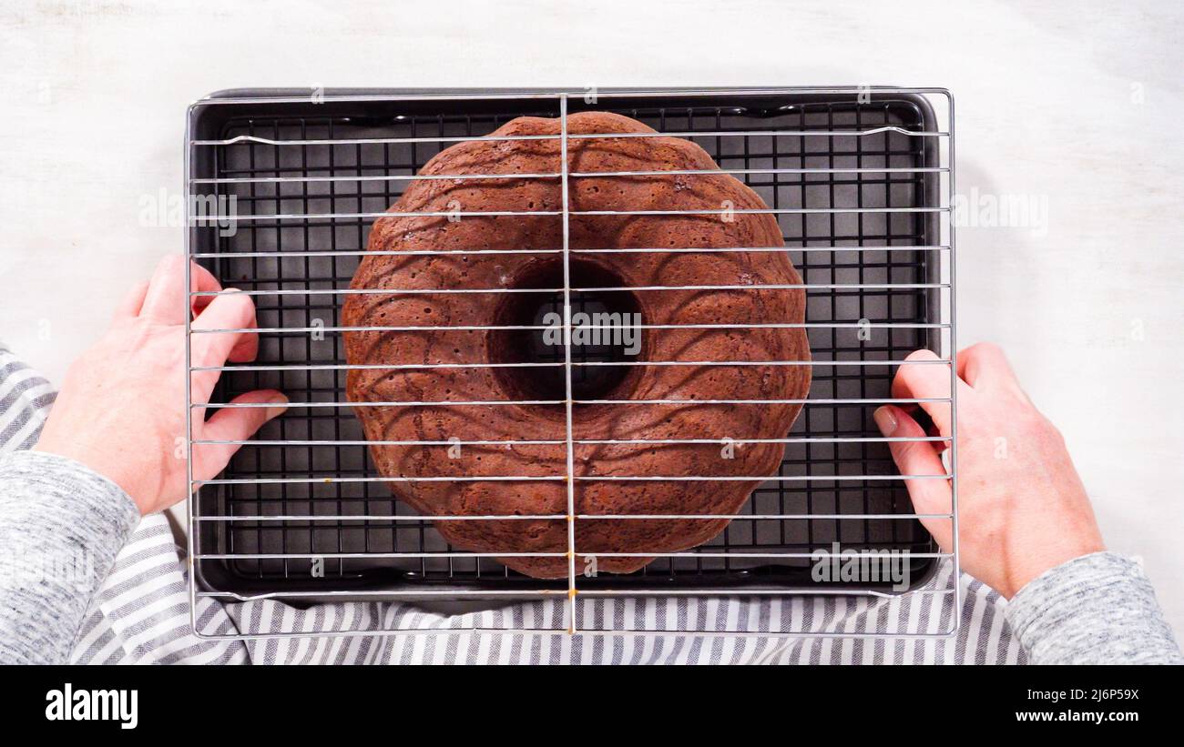 Step by step. Flat lay. Cooling freshly baked chocolate bundt cake on a ...