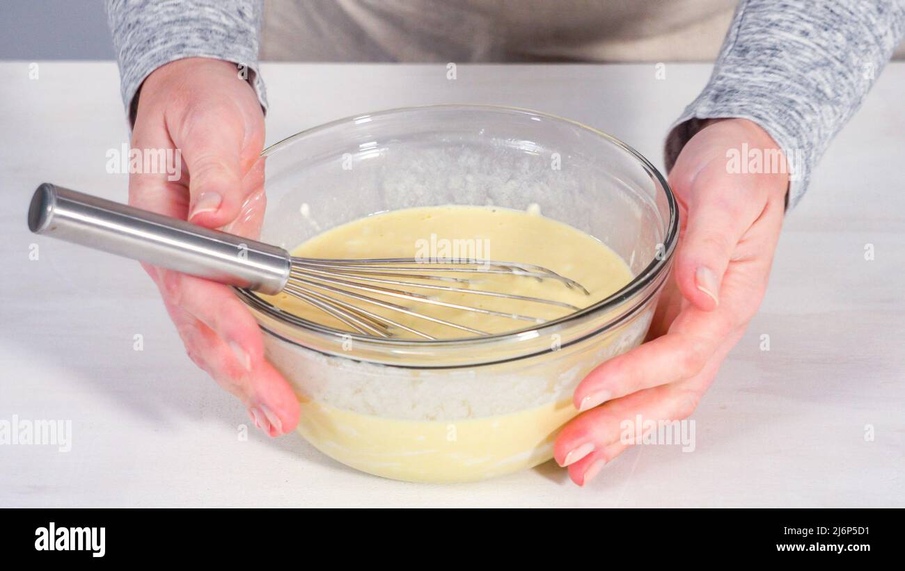Step by step. Mixing ingredients in a glass mixing bowl to bake ...