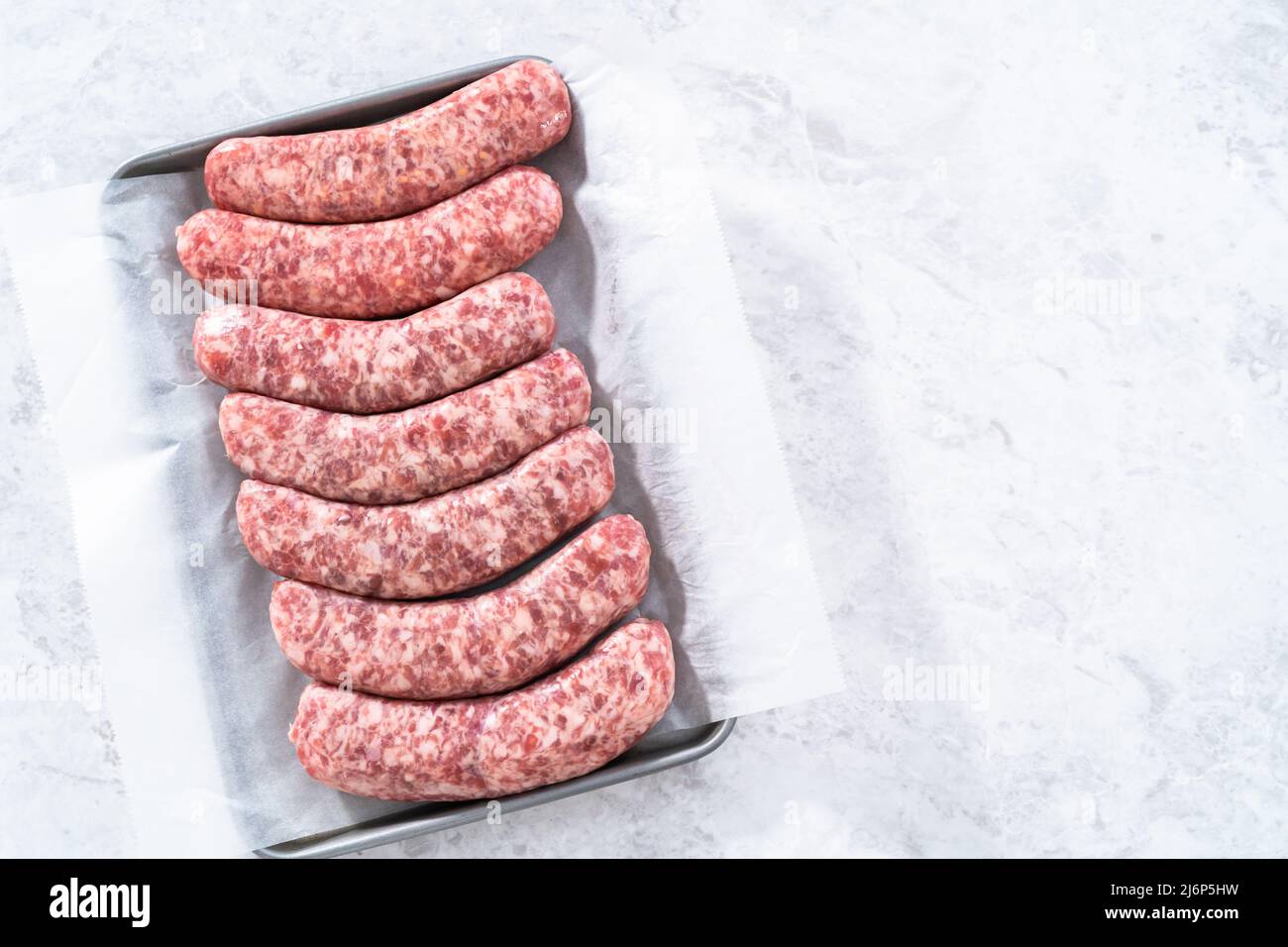 Raw beer bratwursts in the row on a small tray Stock Photo - Alamy