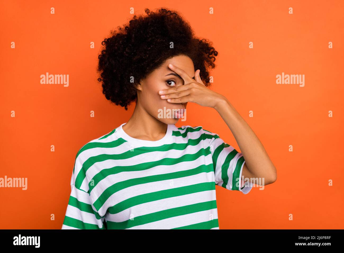 Portrait of attractive funny brunette wavy-haired girl look one eye spy ...