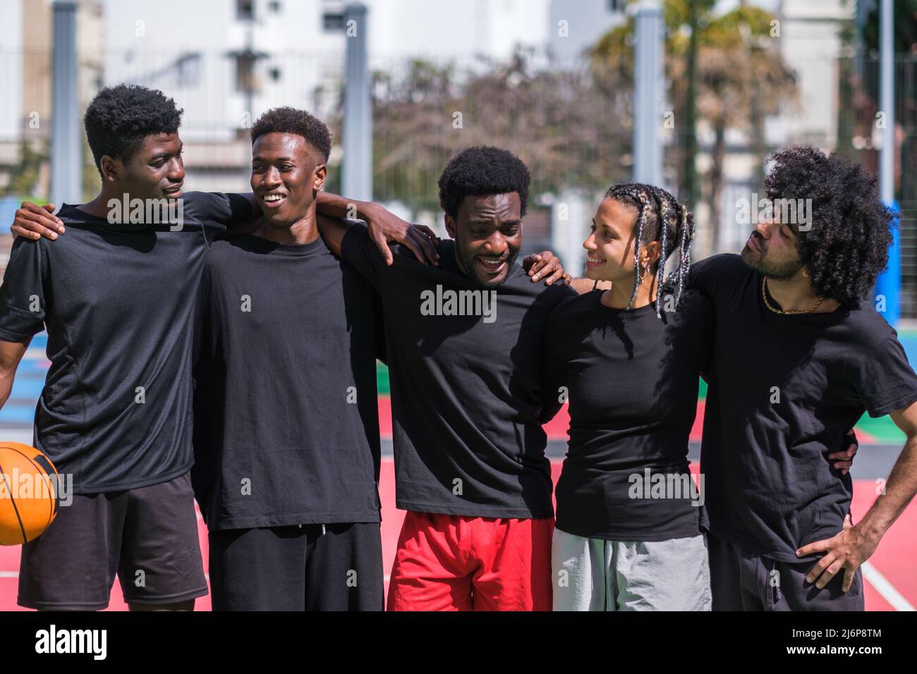 Group of friends together on basketball court Stock Photo - Alamy