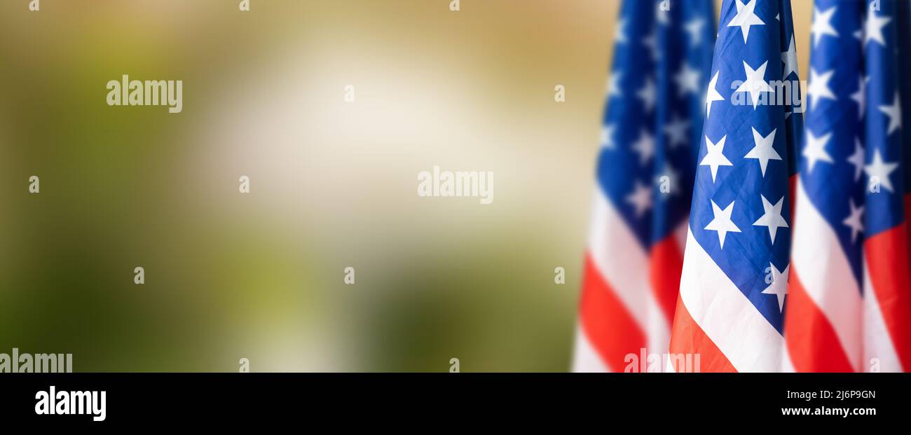 Group of American flags in green background Stock Photo - Alamy