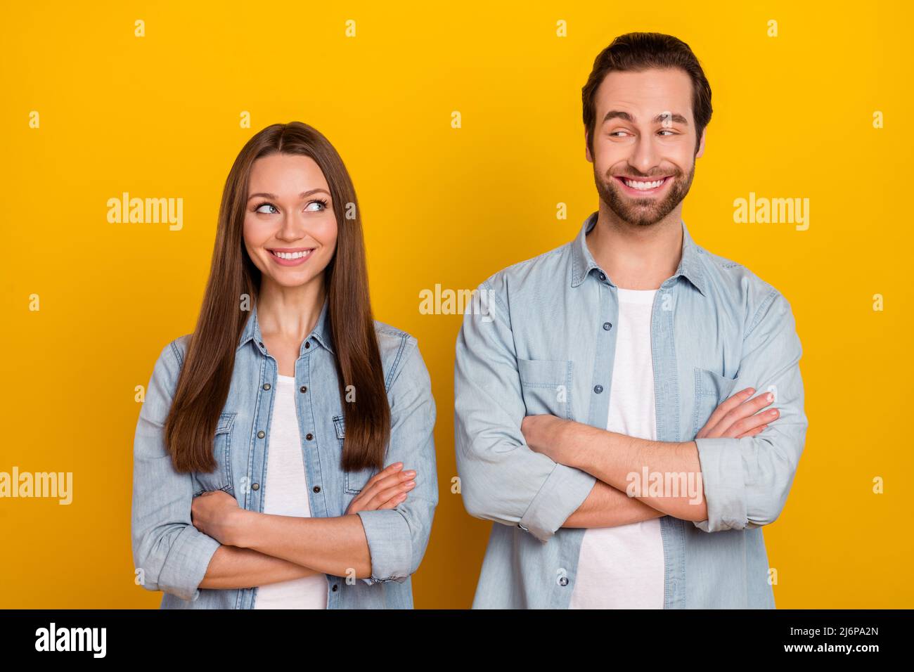 Photo of positive tricky sister brother dressed denim shirts arms ...