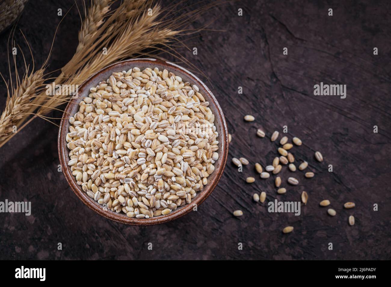 Organic uncooked dried barley cereal grain in a bowl Stock Photo - Alamy