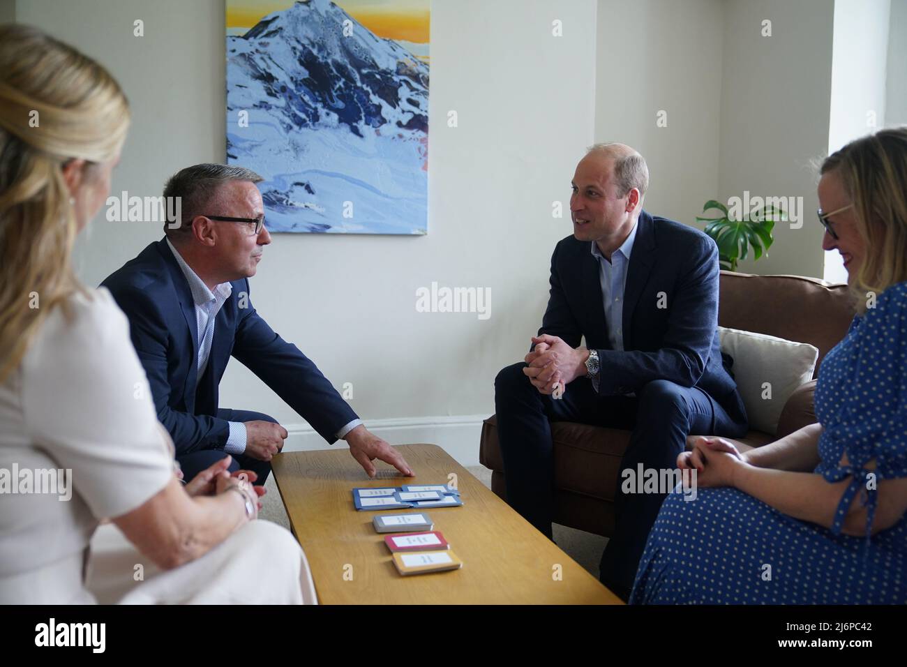 The Duke of Cambridge meets client Derek Wilson as he views cards used ...