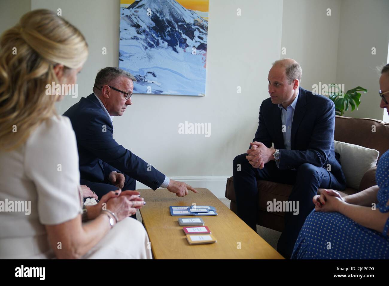 The Duke of Cambridge meets client Derek Wilson as he views cards used ...