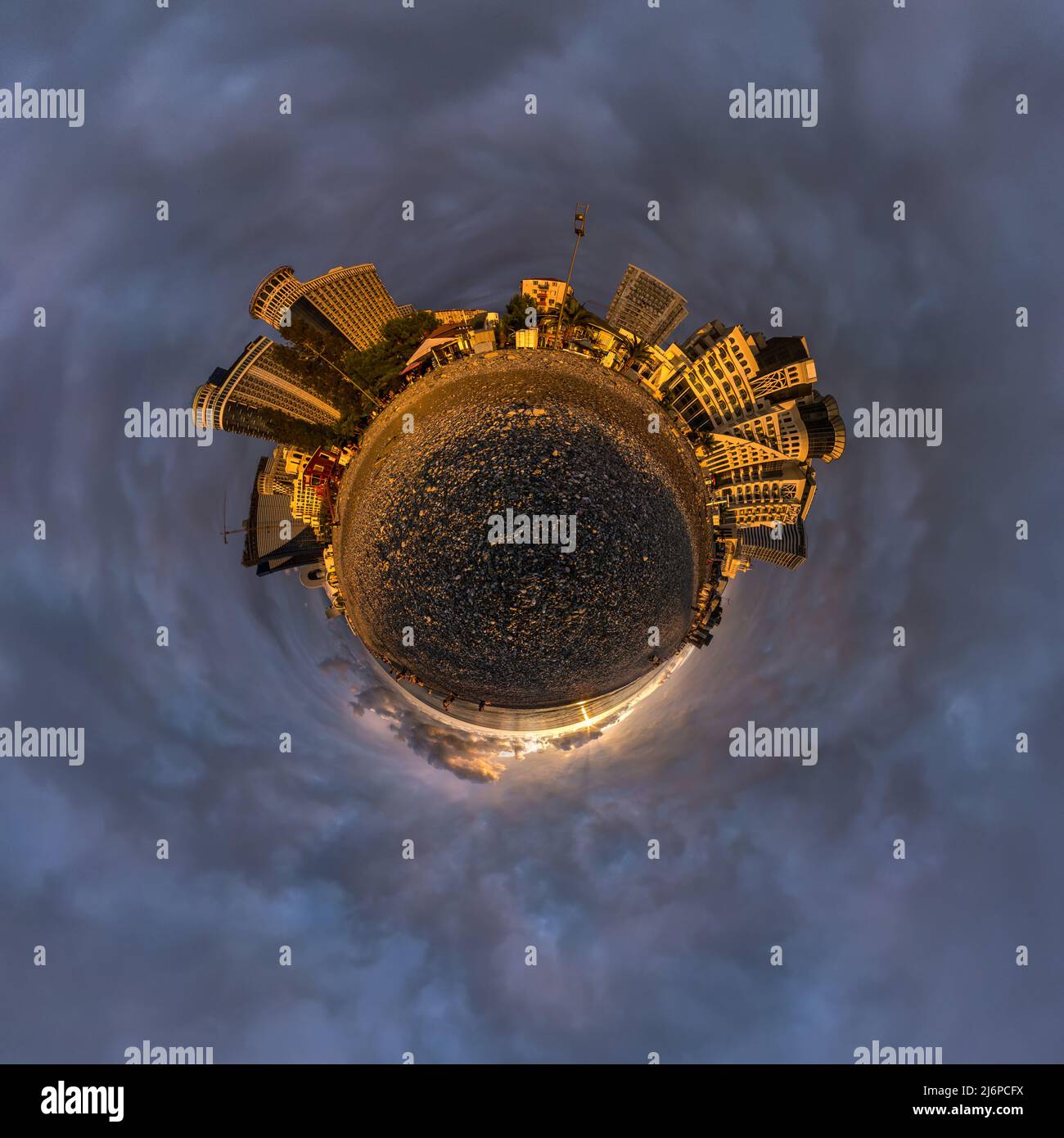 tiny planet in evening sky in city center near modern skyscrapers near ...
