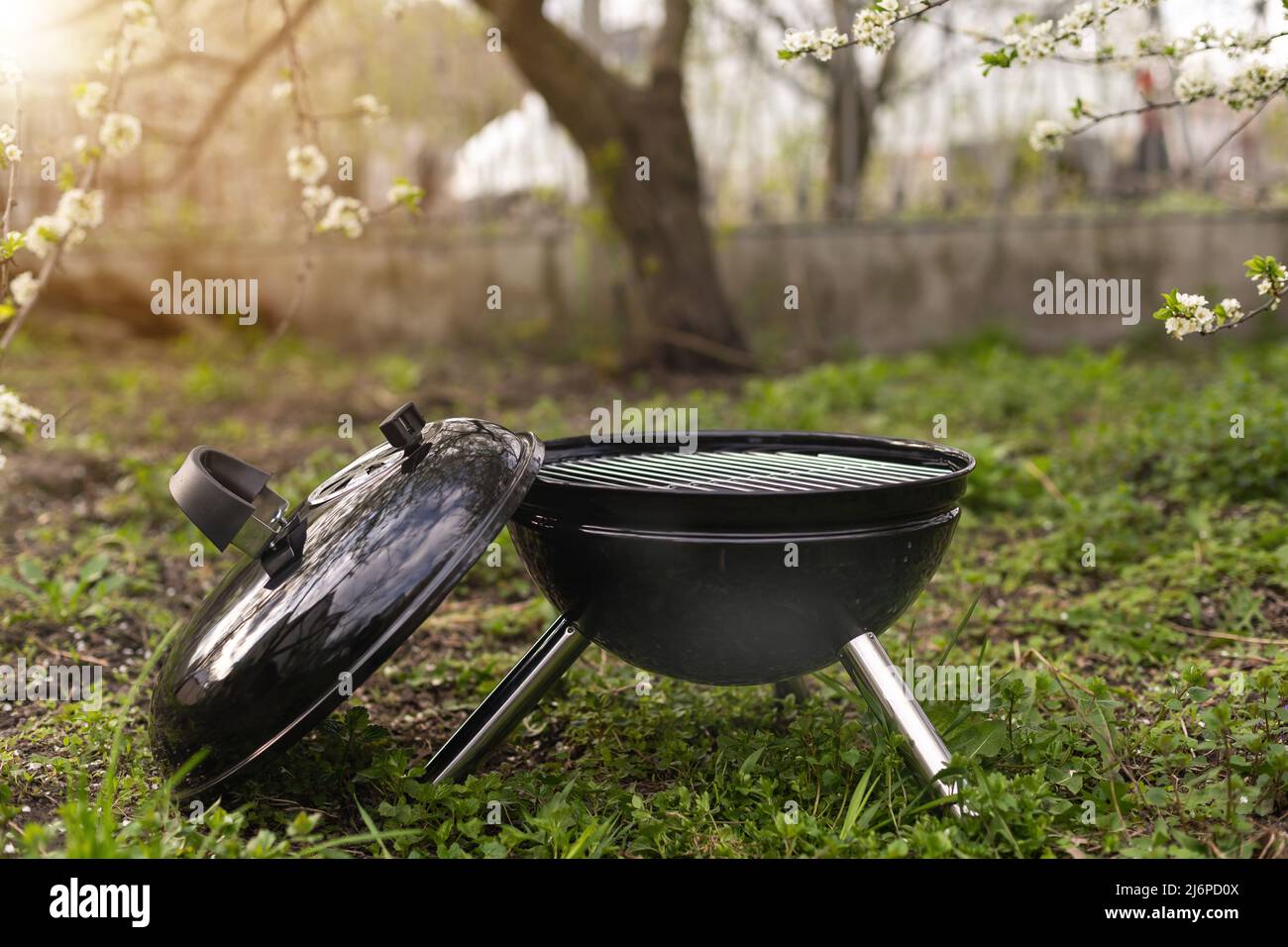 An empty barbecue grill stands in the yard Stock Photo - Alamy