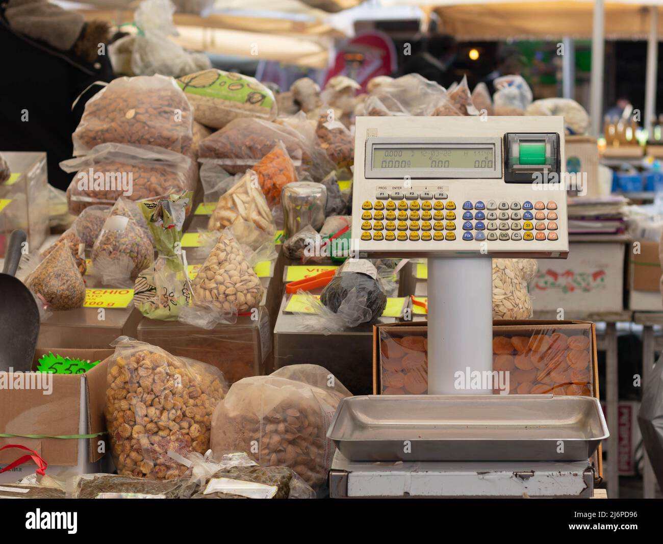 Weight scale in a street market stand sorrounded by a variety of ...