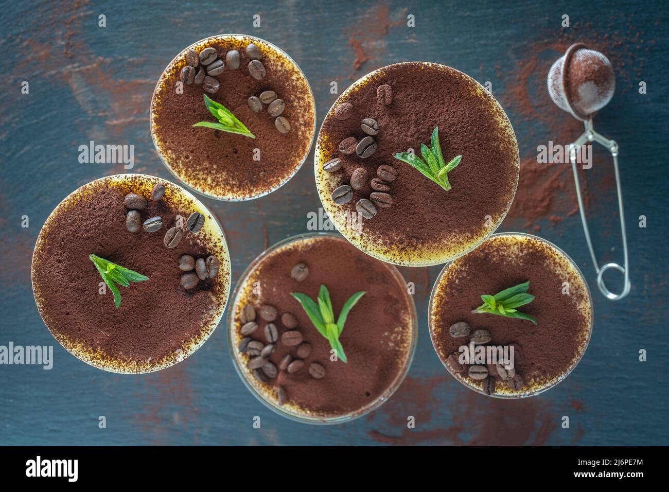 Traditional Italian dessert tiramisu decorated with cocoa powder ...