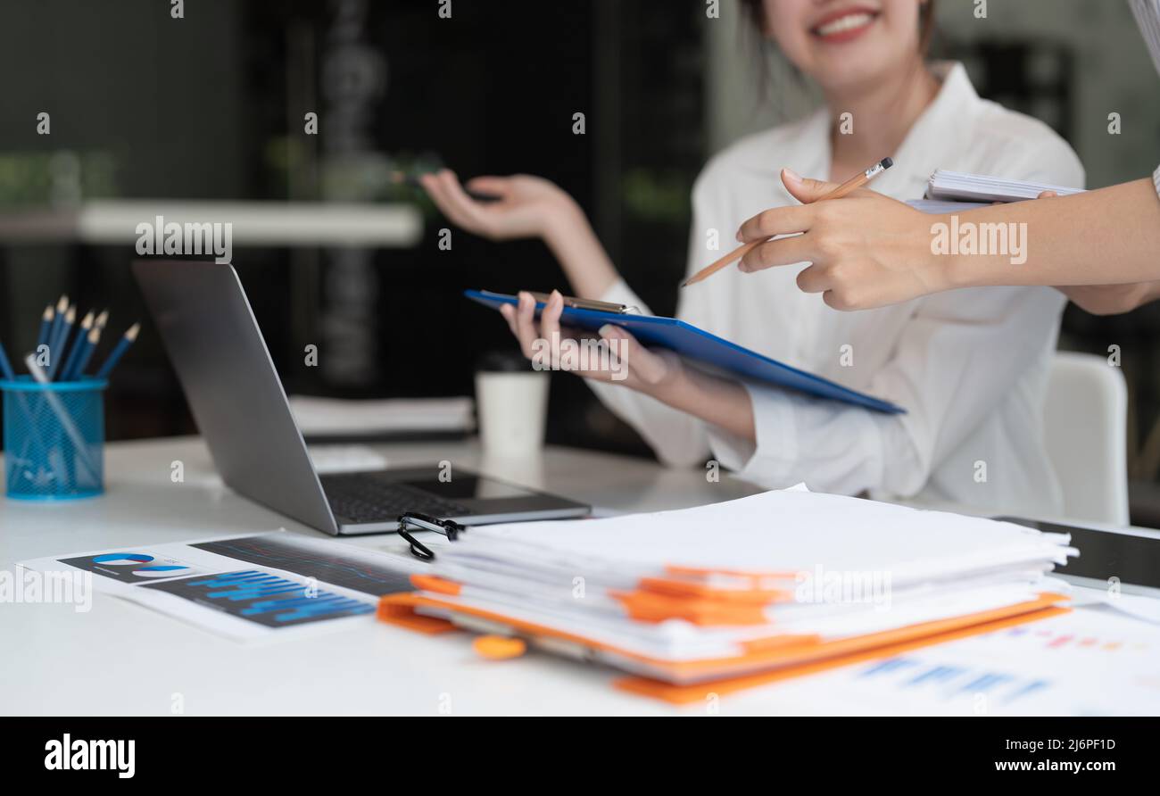 Business people discussing the charts and graphs showing the results of ...