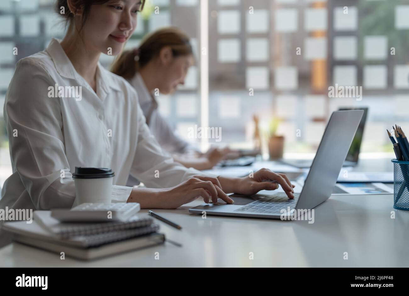 Close up busiess asian woman working with laptop computer for financial ...