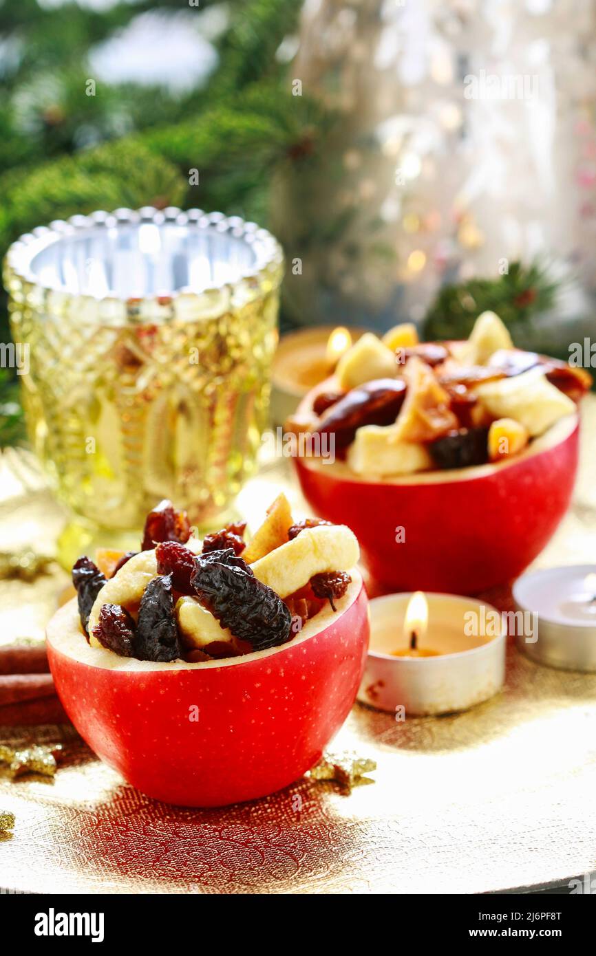 Red christmas apples stuffed with dried fruits in honey. Festive decor ...