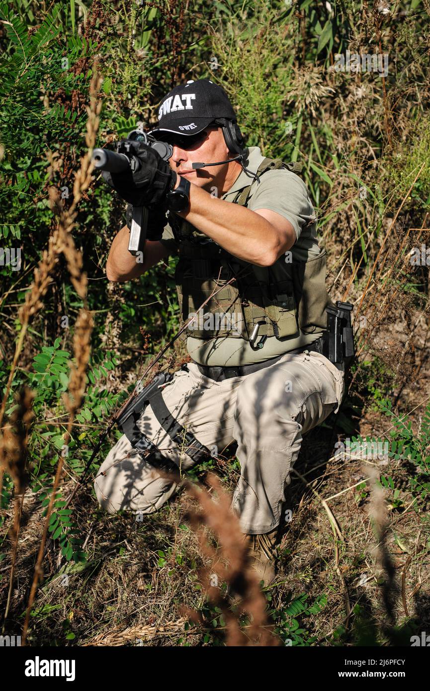 Army soldier shooting with rifle machine gun in the forest. Nature ...