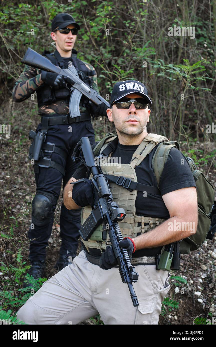 Army soldiers shooting with rifle machine gun in the forest. Nature ...