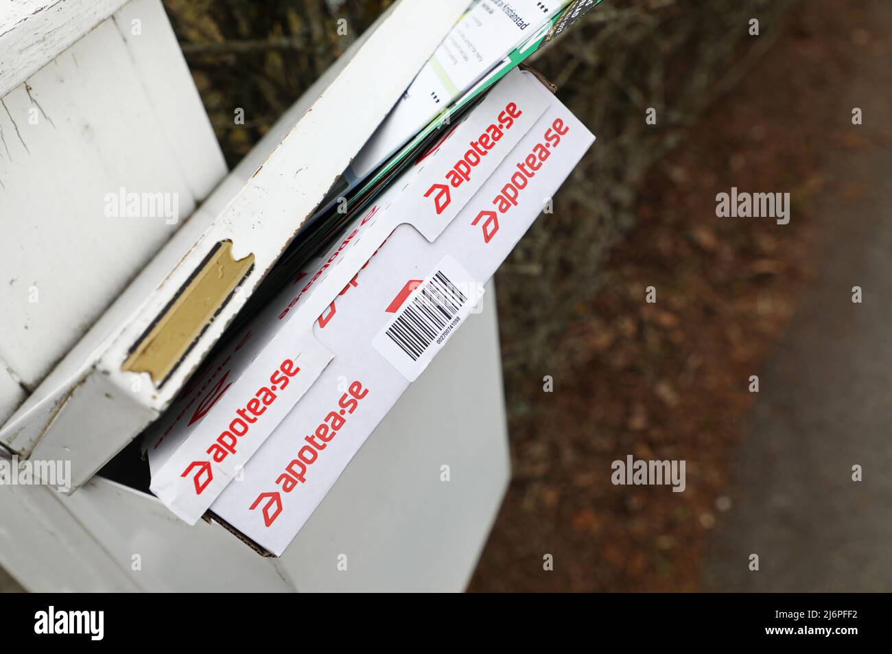 Package from the online pharmacy Apotea AB delivered in a mailbox at a ...