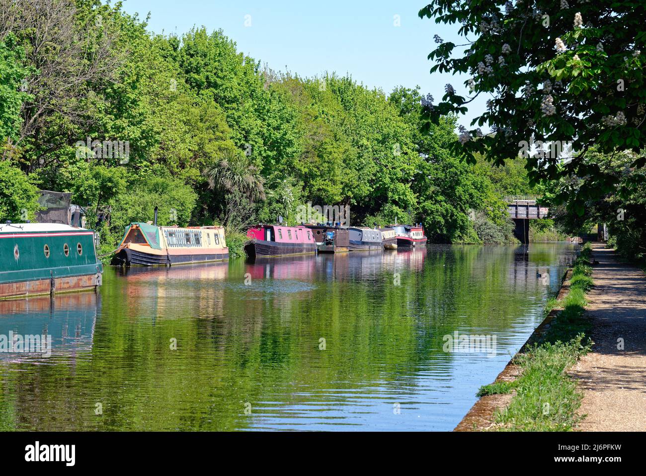 The Paddington branch of the Grand Union Canal with moored houseboats ...