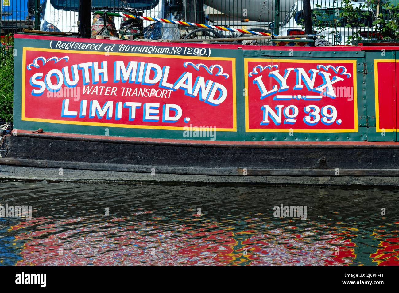Traditional artwork and hand painted lettering on the side of a narrow ...