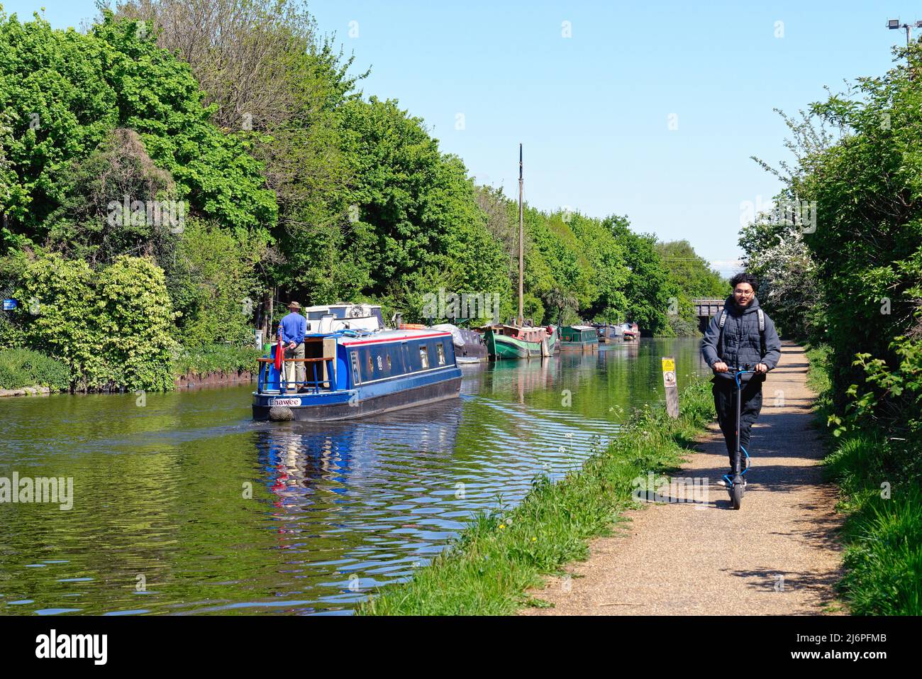 A narrow boat cruising on the Paddington branch of the Grand Union ...