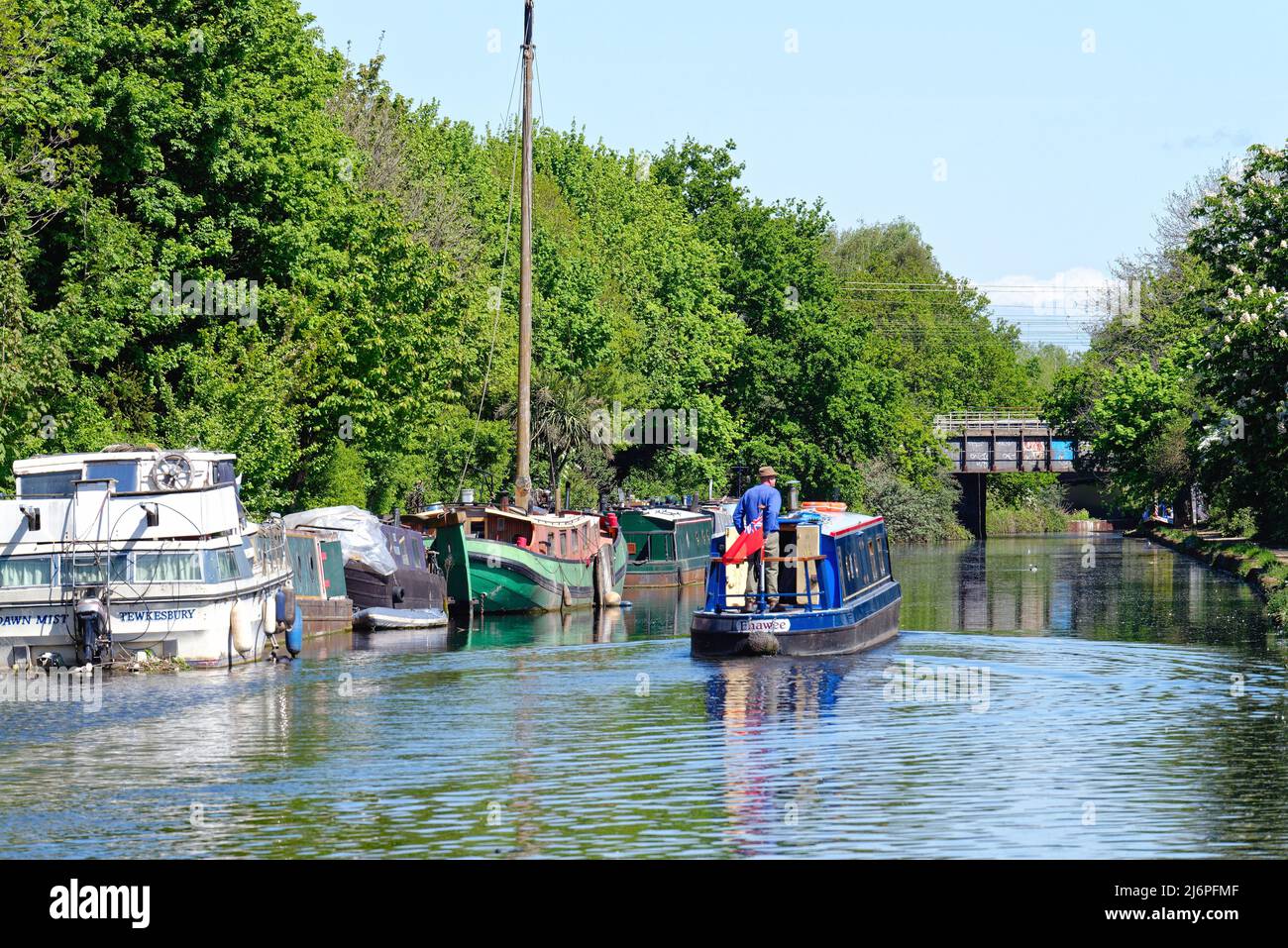 A narrow boat cruising on the Paddington branch of the Grand Union ...