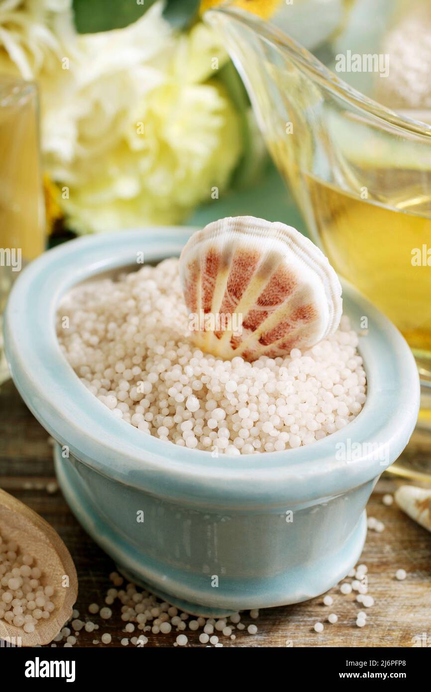 Bowl of sea salt and jug of liquid soap. Spa time Stock Photo - Alamy