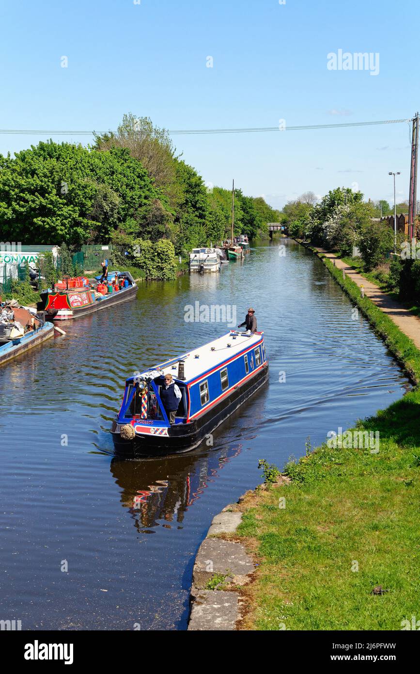 A narrow boat cruising on the Paddington branch of the Grand Union ...
