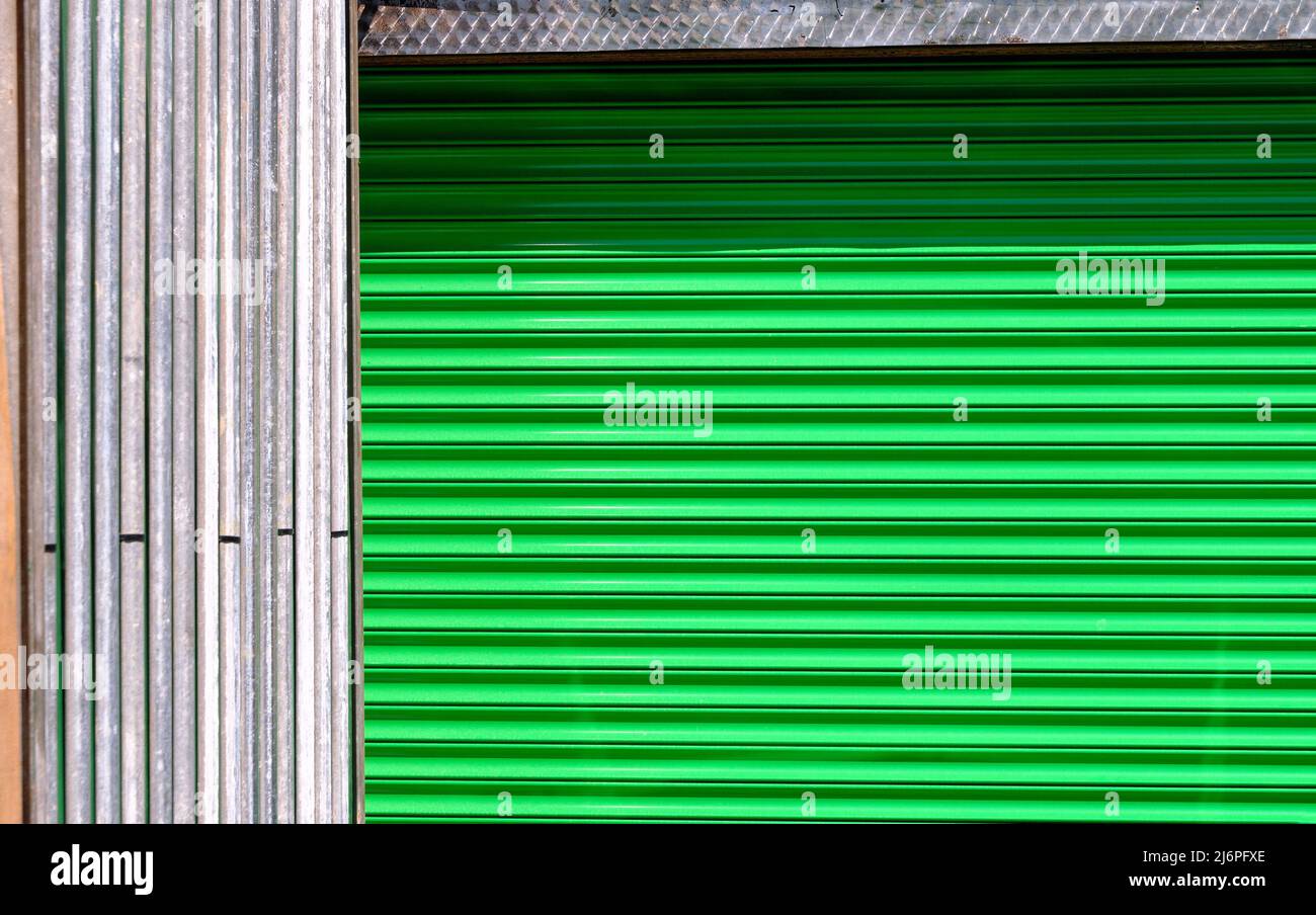 A bright green abstract pattern created by corrugated metal shuttering ...