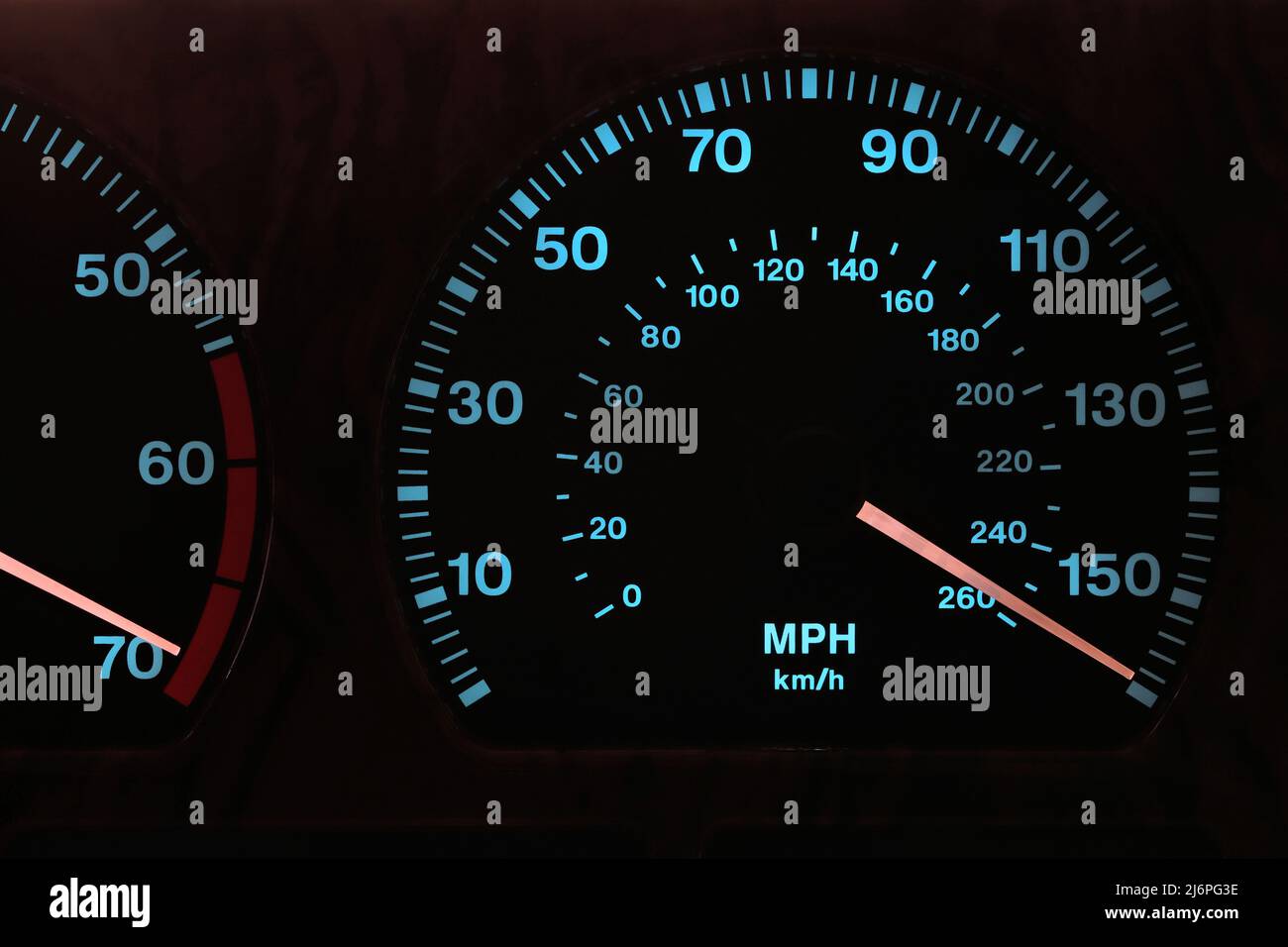 speedometer in car dashboard at full speed in illuminated night mode ...