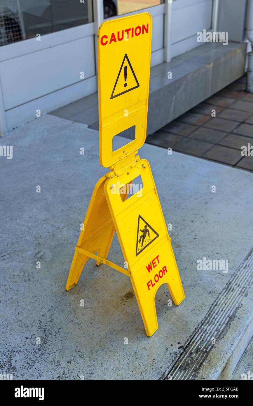 Yellow Plastic Sign Caution Wet Floor at Damaged Surface Stock Photo ...