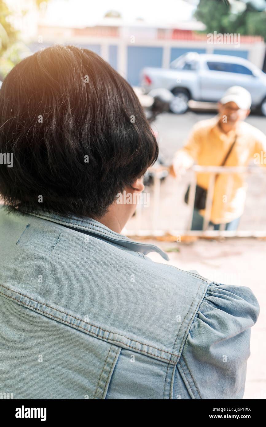 Vertical photo of a Latin woman talking and gossiping with a man from ...