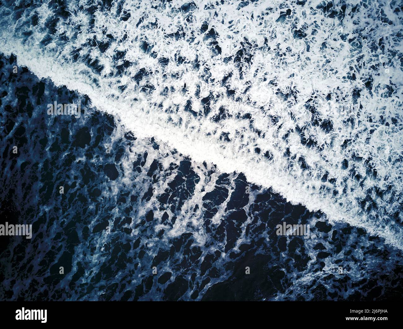 Aerial view of movement of the waves seen from above and the blue ...