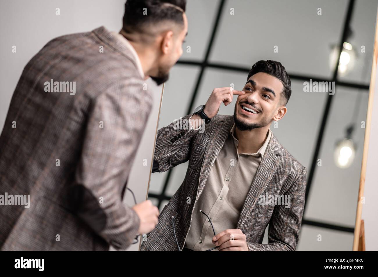 A good-looking young elegant man at the mirror Stock Photo - Alamy
