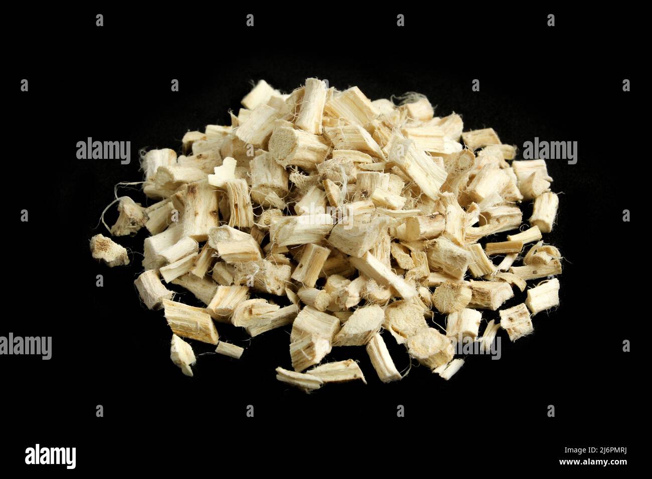 Pile of dry marshmallow roots isolated on black background. Althaea ...