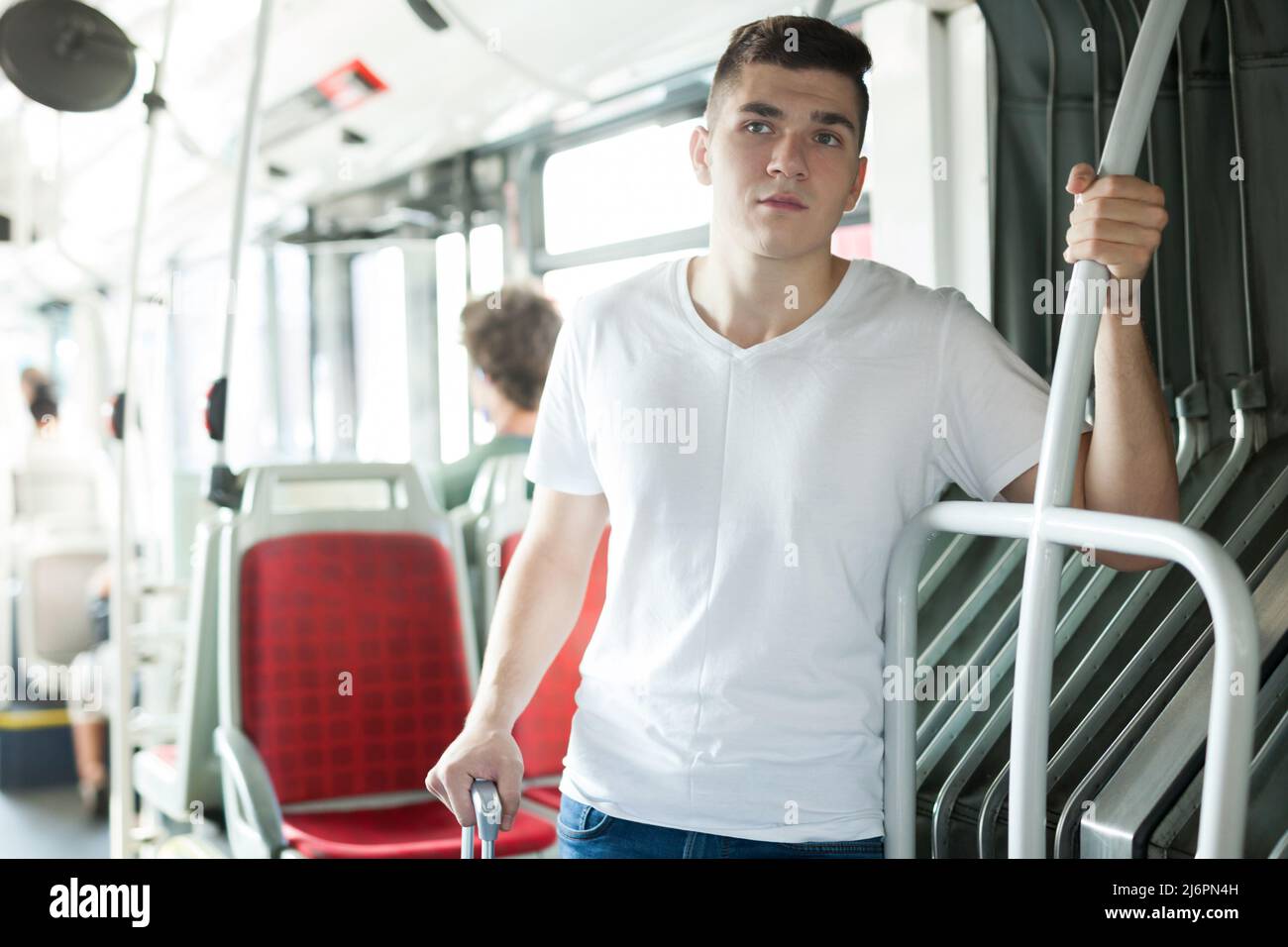 Modern guy standing in public land transport Stock Photo - Alamy