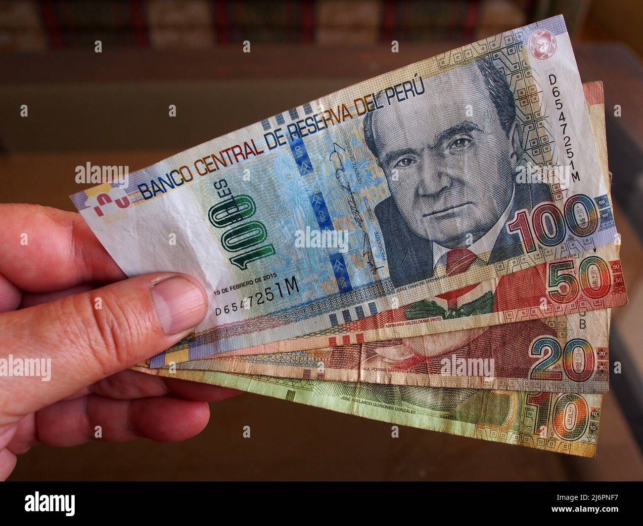 In this photo illustration, Peruvian Sol banknotes being handled. The ...