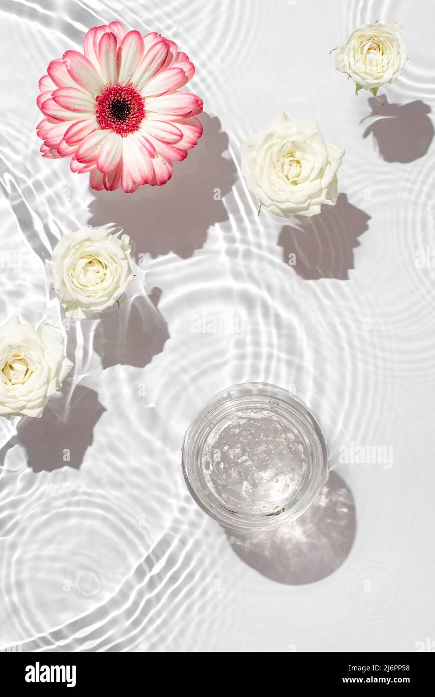 Jar of hydrating gel and flowers Stock Photo - Alamy
