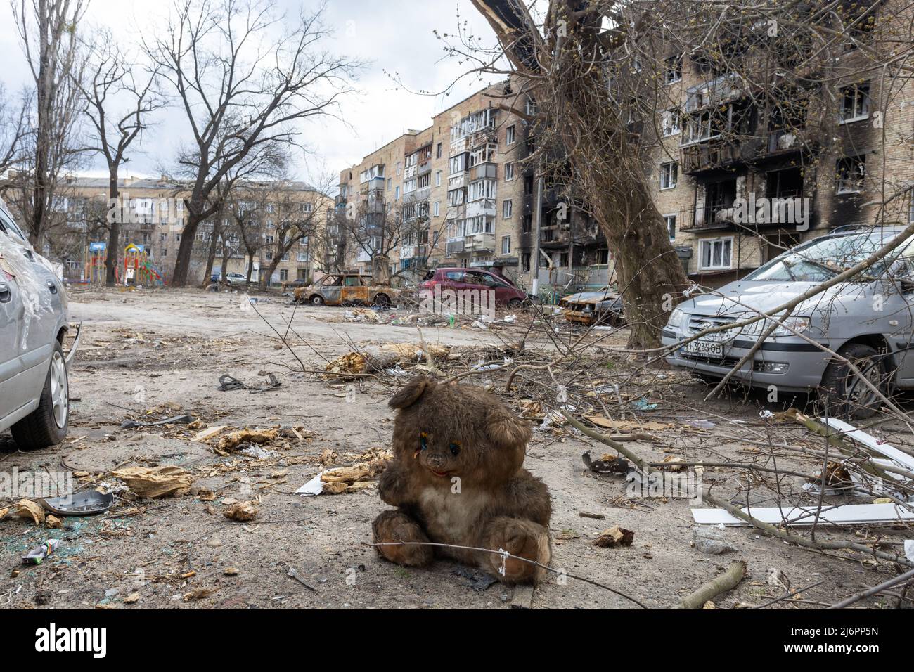 Concept war in Ukraine, a burnt bear toy against the background of a ...
