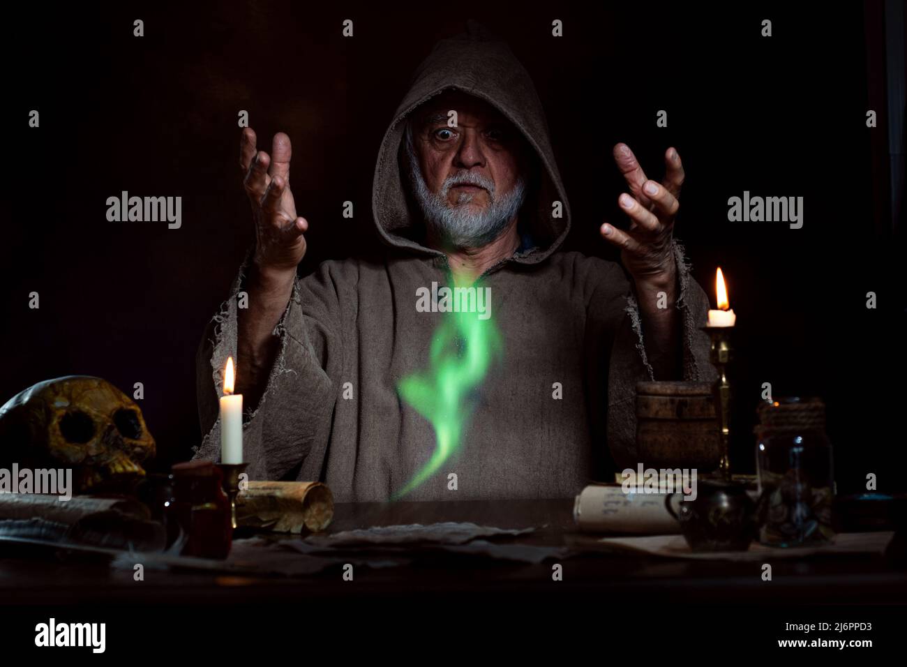 Old sorcerer does magic with his hands Stock Photo - Alamy