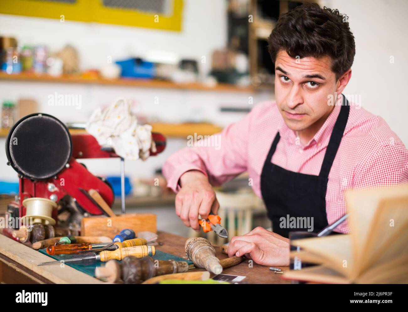 Craftsman in uniform working in carpentry Stock Photo - Alamy