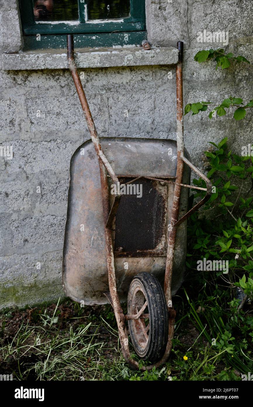 Old worn wheelbarrow hi-res stock photography and images - Alamy