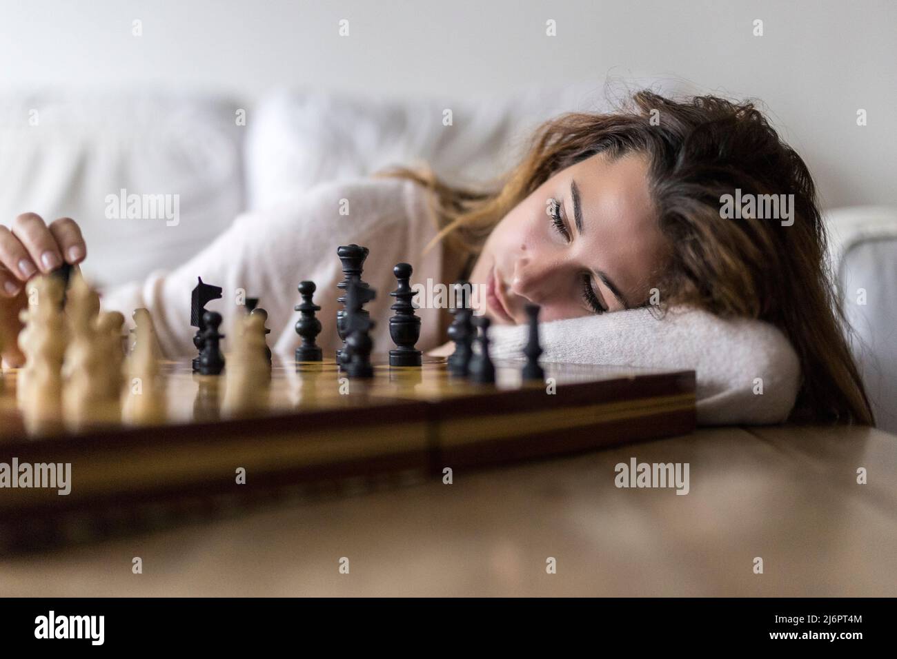 Woman at home playing chess alone Stock Photo - Alamy