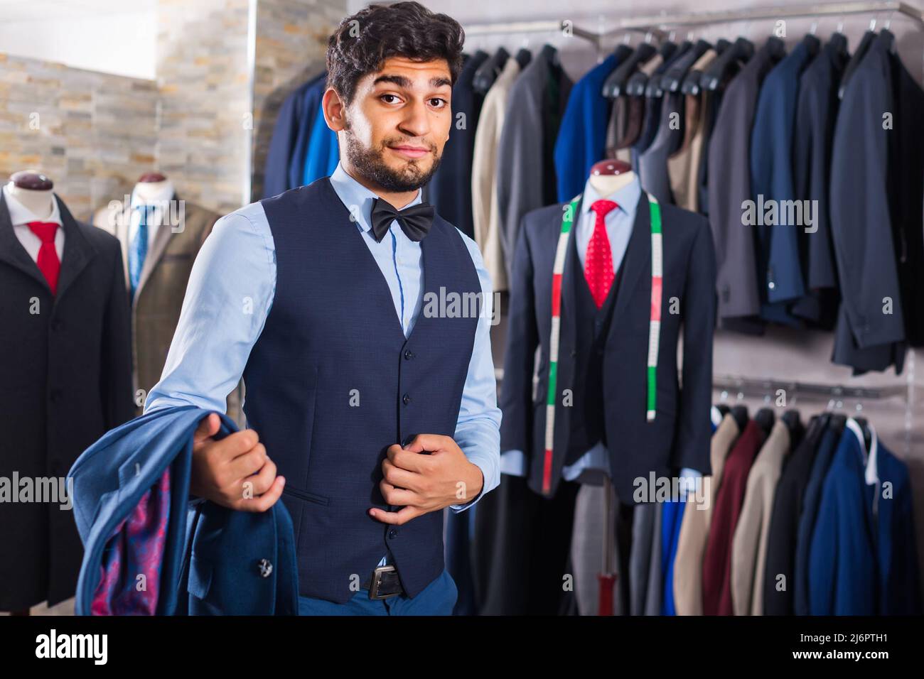 Young male is demonstrating image in waistcoat with butterfly Stock ...