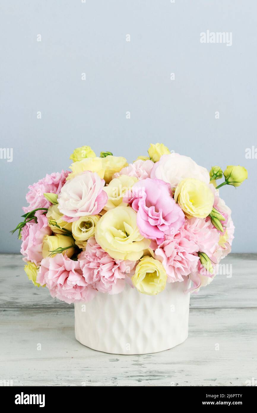 Floral arrangement with pink carnation and yellow eustoma flowers ...
